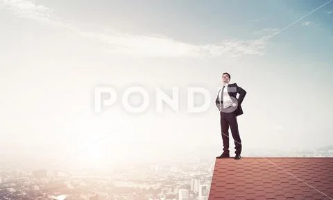 Mister boss on brick roof with arms akimbo. Mixed media Stock Photo ...