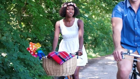 mixed race couple riding bike in park | Stock Video | Pond5