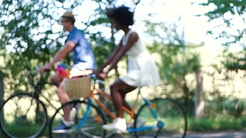 mixed race couple riding bike in park | Stock Video | Pond5