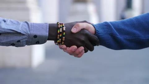 Mixed race handshake. brotherhood, harmo... | Stock Video | Pond5