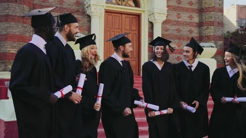 Mixed races friends of graduates standin... | Stock Video | Pond5