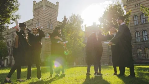 Mixed races happy graduates hugging and ... | Stock Video | Pond5