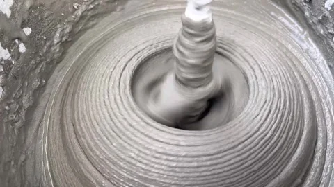 Mixing cement mortar with a mixer in a b... | Stock Video | Pond5