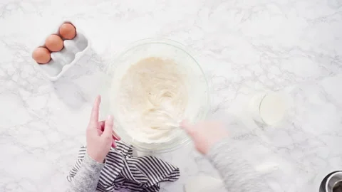 Mixing ingredient in a glass mixing bowl... | Stock Video | Pond5