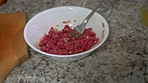 Mixing ingredients with raw meat for tar... | Stock Video | Pond5