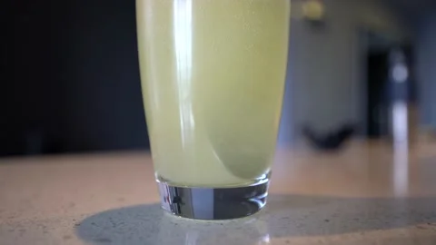 Mixing lemon fizzy drink into water with... | Stock Video | Pond5