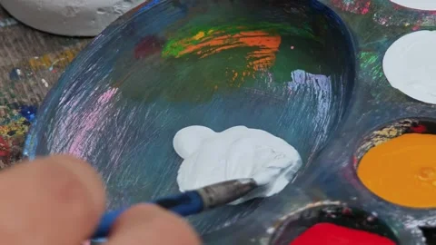 Mixing paint to create new color on a pa... | Stock Video | Pond5