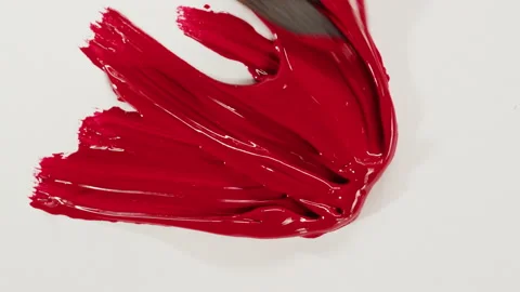 Mixing red paint close-up. Drawing on wh... | Stock Video | Pond5