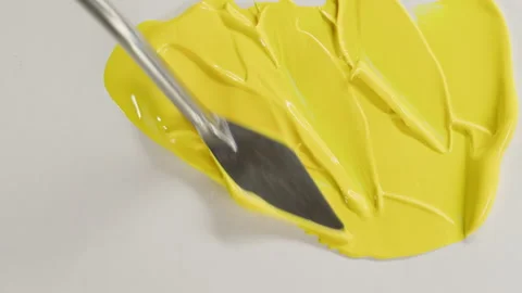 Mixing yellow paint close-up. Drawing on... | Stock Video | Pond5