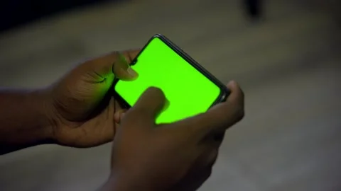 mobile green screen in man hand playing ... | Stock Video | Pond5