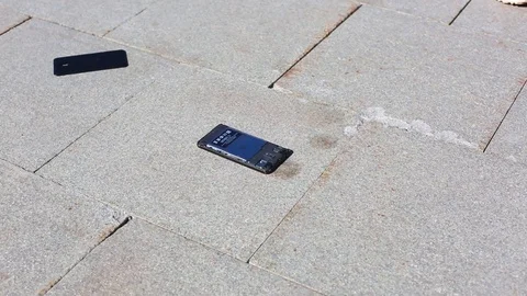 Mobile phone is falling on the ground an... | Stock Video | Pond5