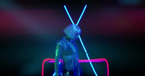 Model in a dark studio with blue neon li... | Stock Video | Pond5