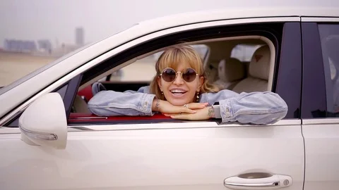 Model posing in car. | Stock Video | Pond5