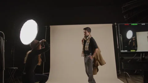 Model Takes Coat Off While Posing For Ph... | Stock Video | Pond5