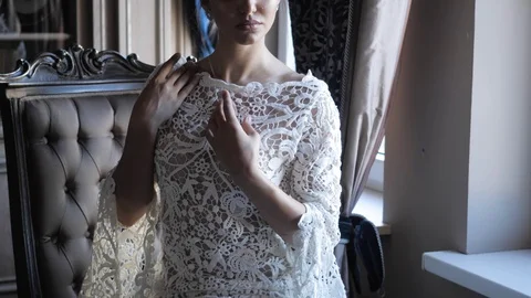 model in white lacy dress poses with han... | Stock Video | Pond5