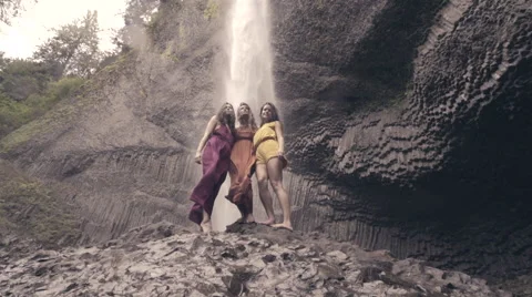 Models Pose On Rocks Below Waterfall In ... | Stock Video | Pond5