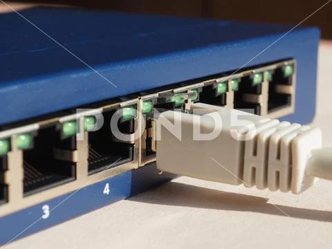 Photograph: Modem router switch with RJ45 ethernet plug ports #85923102
