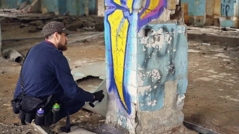 Modern graffiti painter is squatting nea... | Stock Video | Pond5