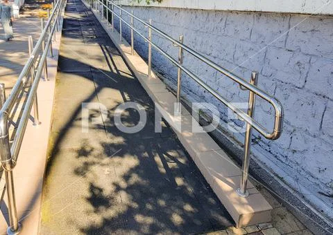 Modern ramp with shiny metal railings in the open air, for wheelchair ...