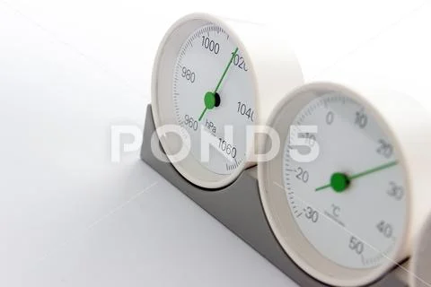 Modern, round barometer, thermometer, hygrometer. Analog device for ...