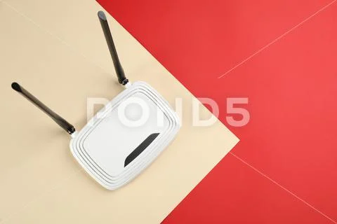 Modern Wi-Fi router on color background, top view. Space for text Stock ...