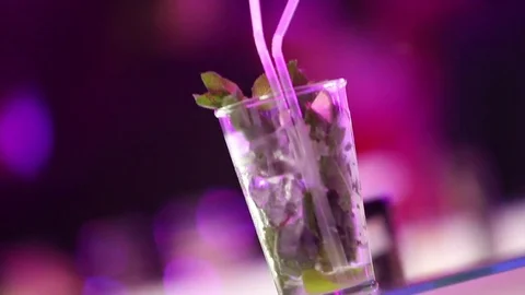 Mojito cocktail, party in the background | Stock Video | Pond5