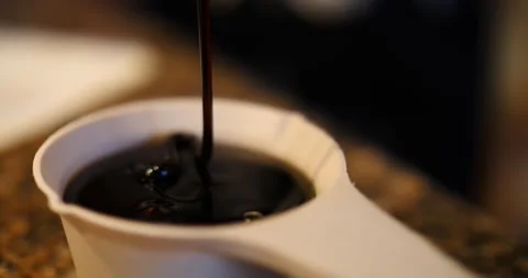 Molasses being poured into measuring cup... | Stock Video | Pond5