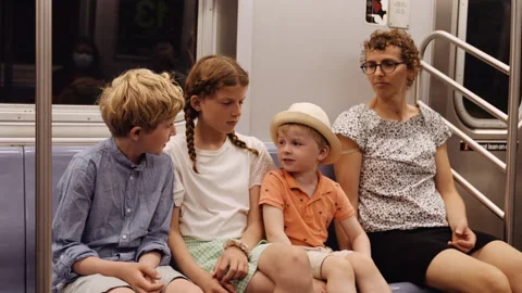 Mom with 3 Kids Ride Subway. They Sit In... | Stock Video | Pond5