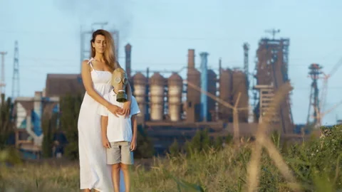 Mom and son in a gas mask stand in the b... | Stock Video | Pond5