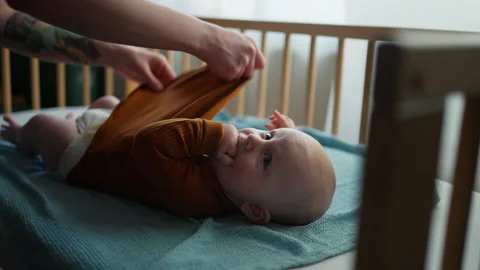 Mom changing baby diaper. 5 months Toddl... | Stock Video | Pond5