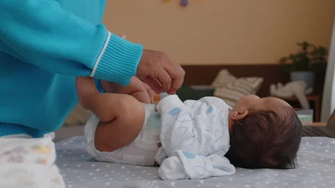Mom Changing Baby Diaper at Home | Stock Video | Pond5
