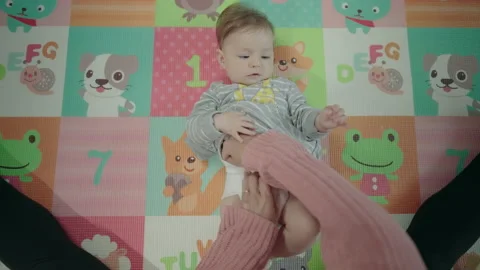 Mom changing her baby daughter's diaper ... | Stock Video | Pond5