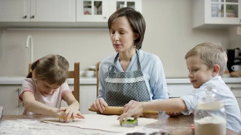 mom control how children make biscuits w... | Stock Video | Pond5