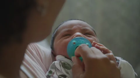 Mom Gives Crying Baby A Pacifier | Stock Video | Pond5