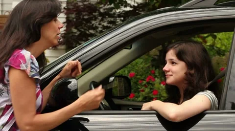 Mom giving teenage girl keys to car | Stock Video | Pond5