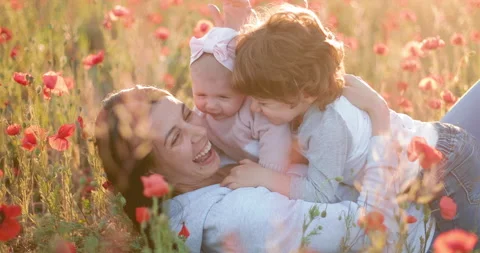 Mom with kids playing in a poppy field a... | Stock Video | Pond5