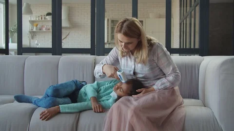 Mom measuring temperature of sick girl w... | Stock Video | Pond5