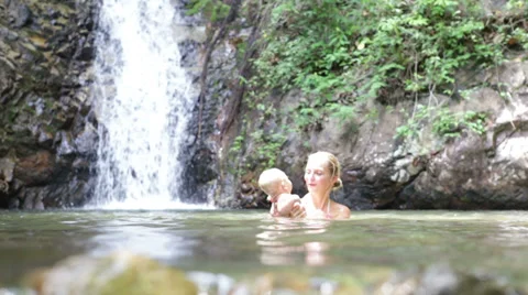 mom play baby waterfall | Stock Video | Pond5