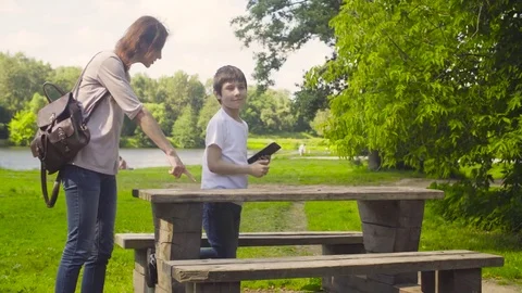 Mom trying to take tablet away from her ... | Stock Video | Pond5
