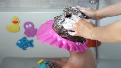 Mom's bathing baby in the bathroom | Stock Video | Pond5