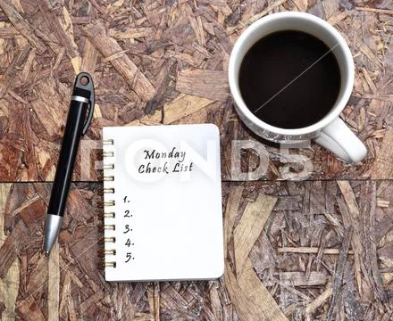 Monday check list written on note pad with background of cup of coffee ...