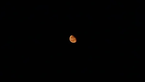 Moon turning red from a fire below | Stock Video | Pond5