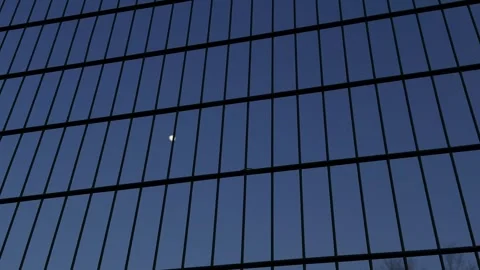 The moon is visible through a grid or fe... | Stock Video | Pond5