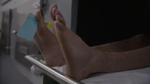 Morgue feet toe tag close up dead body | Stock Video | Pond5