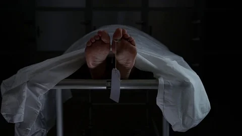 Morgue spooky dangling toe tag on body | Stock Video | Pond5