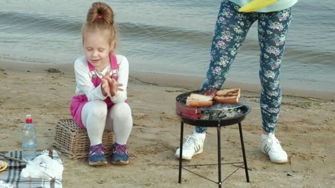 Mother and daughter fry meat and vegetab... | Stock Video | Pond5