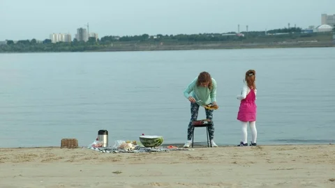 Mother and daughter fry meat and vegetab... | Stock Video | Pond5