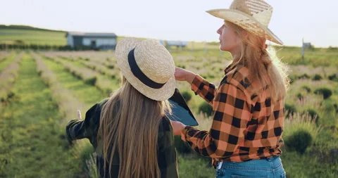 Mother and daughter working on farm. Two... | Stock Video | Pond5