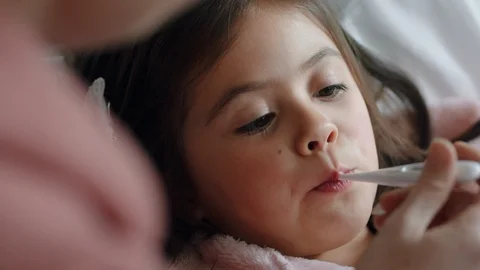 mother caring for sick child lying in be... | Stock Video | Pond5