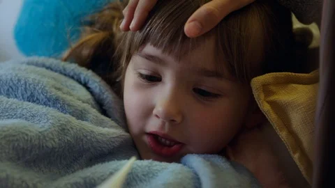 mother caring for sick child lying in be... | Stock Video | Pond5